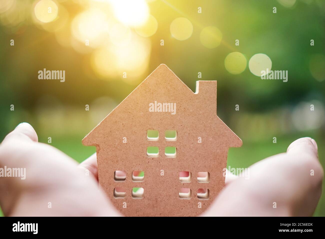 Copy space model of a little house that woman holds it background. Deam ...