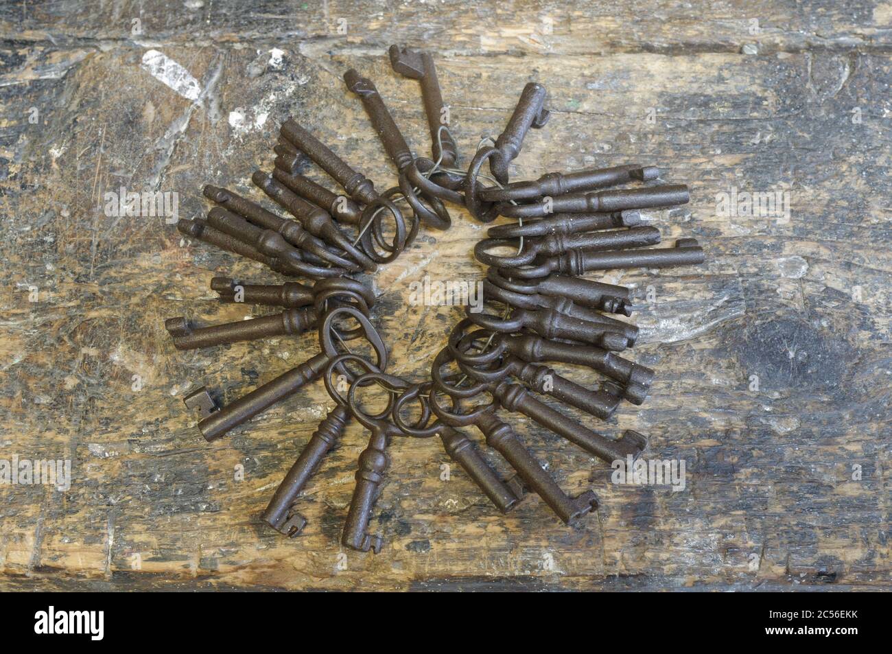 Horizontal shot of many old keys in a single chain placed on a ...