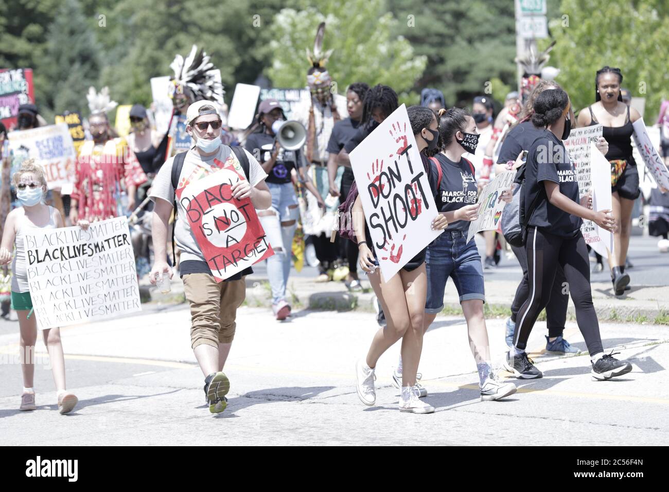A group of protesters march with placards to support anti racism and ...
