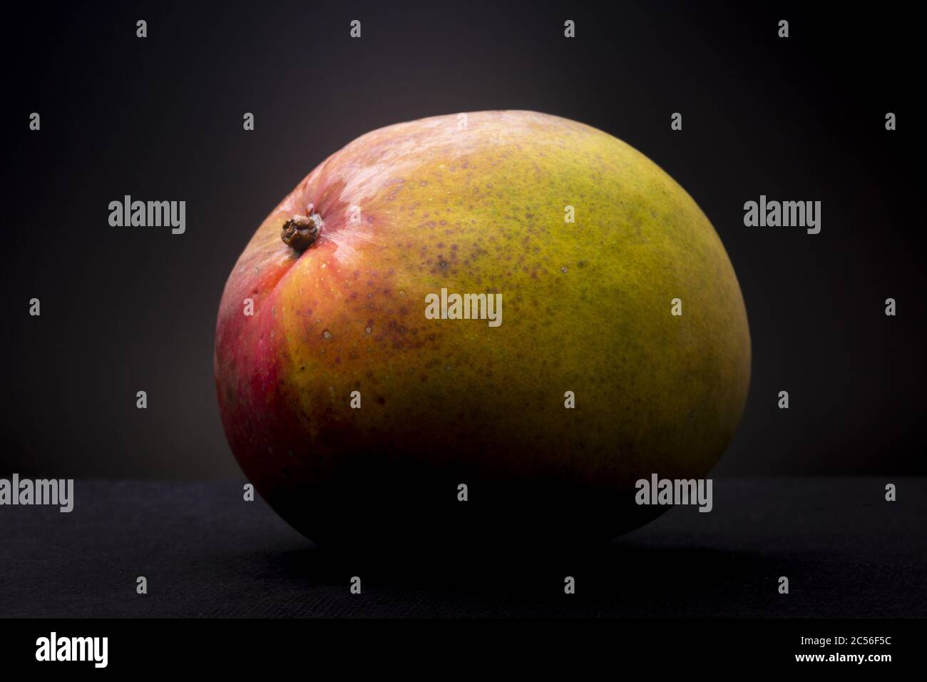 Low key still life of fresh colourful mango fruit Stock Photo - Alamy
