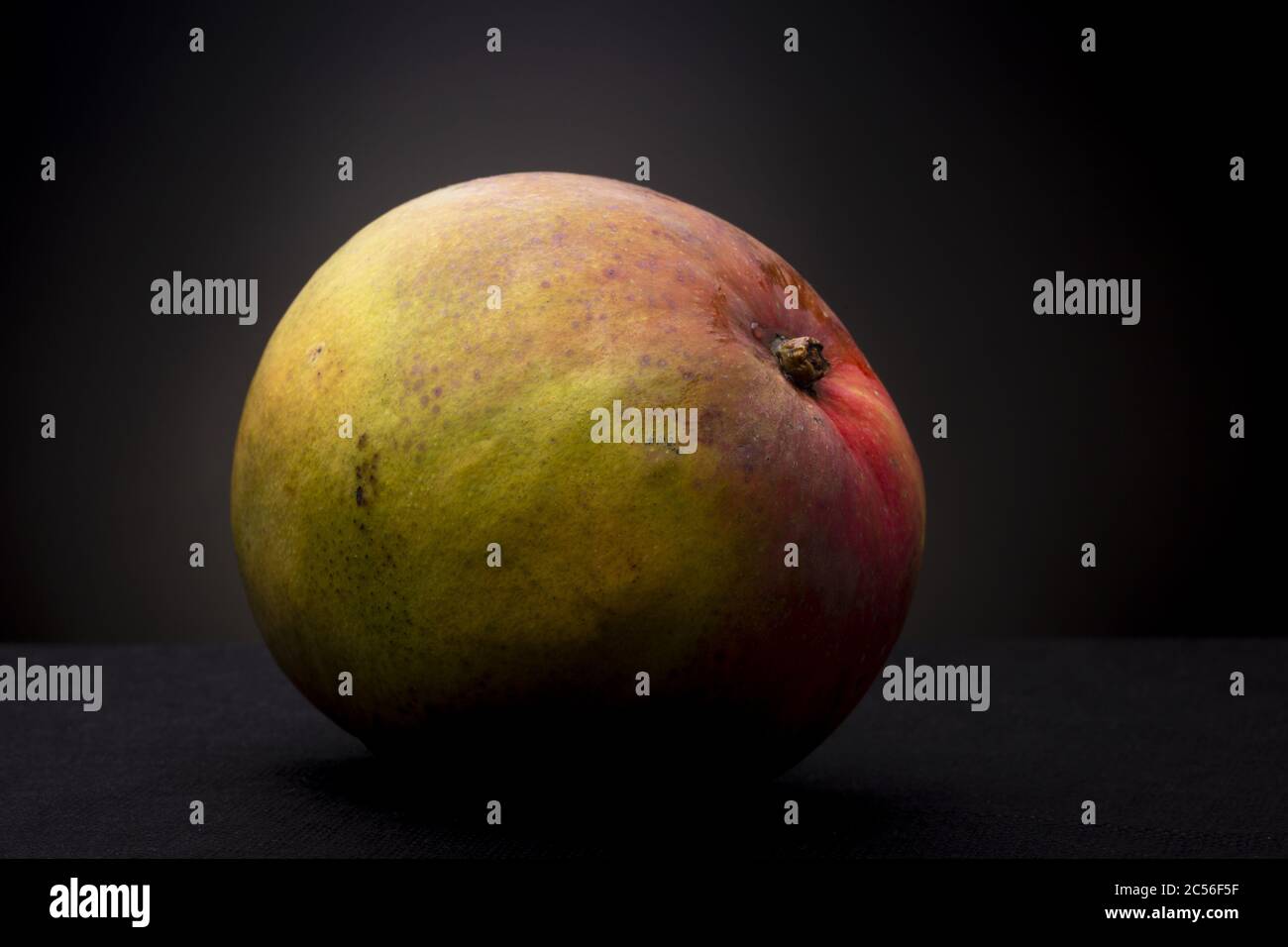 Low key still life of fresh colourful mango fruit Stock Photo - Alamy