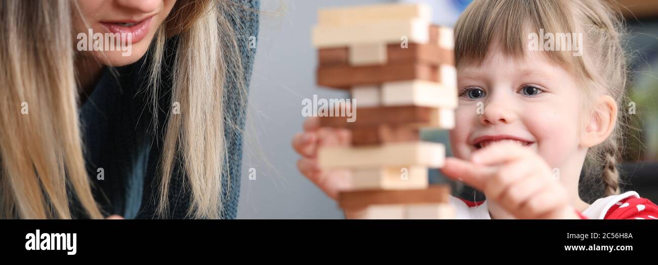 Mom and daughter stack blocks on top each other Stock Photo - Alamy