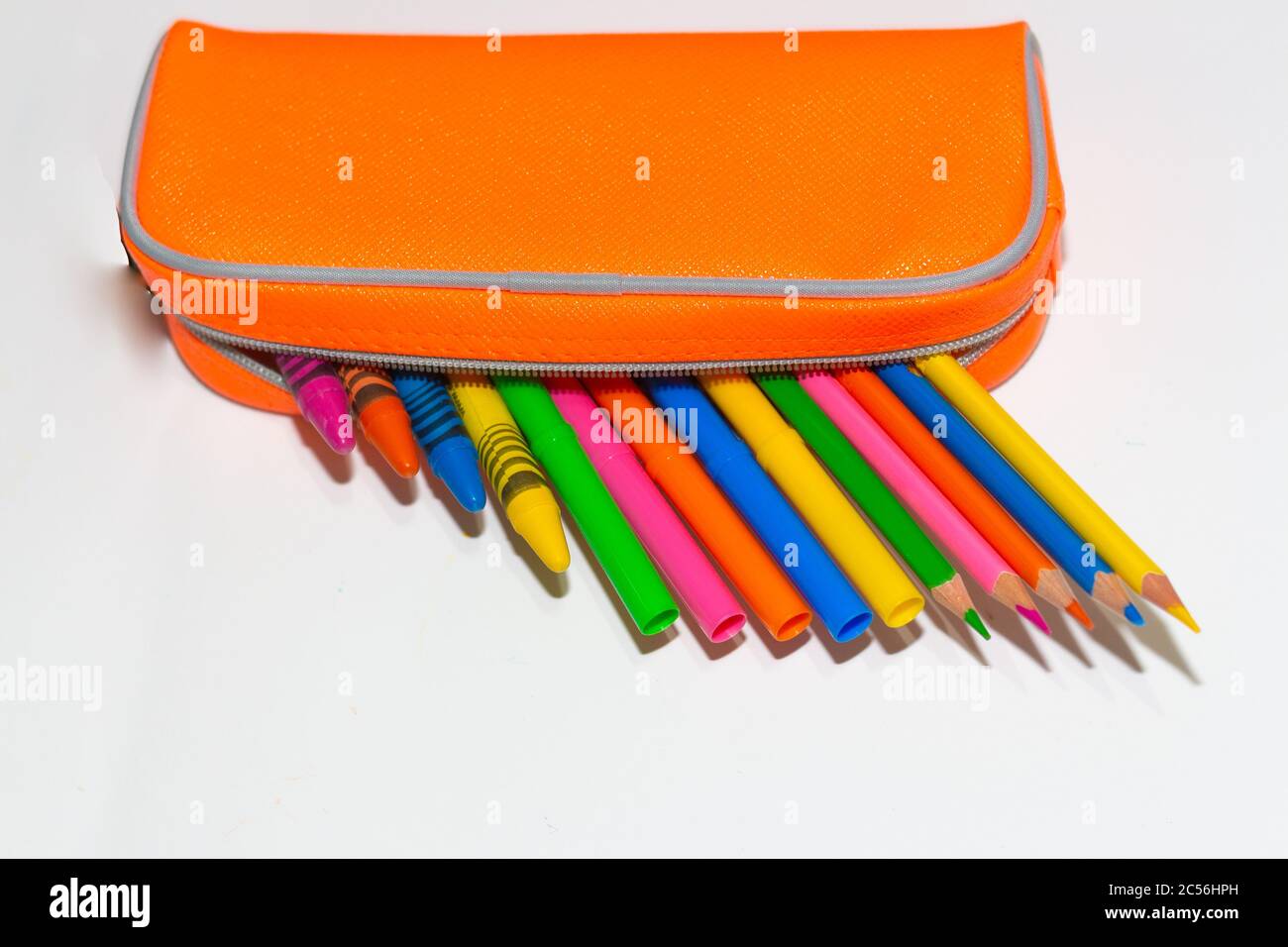 Closeup shot of colored pencils and pouch isolated on white background ...