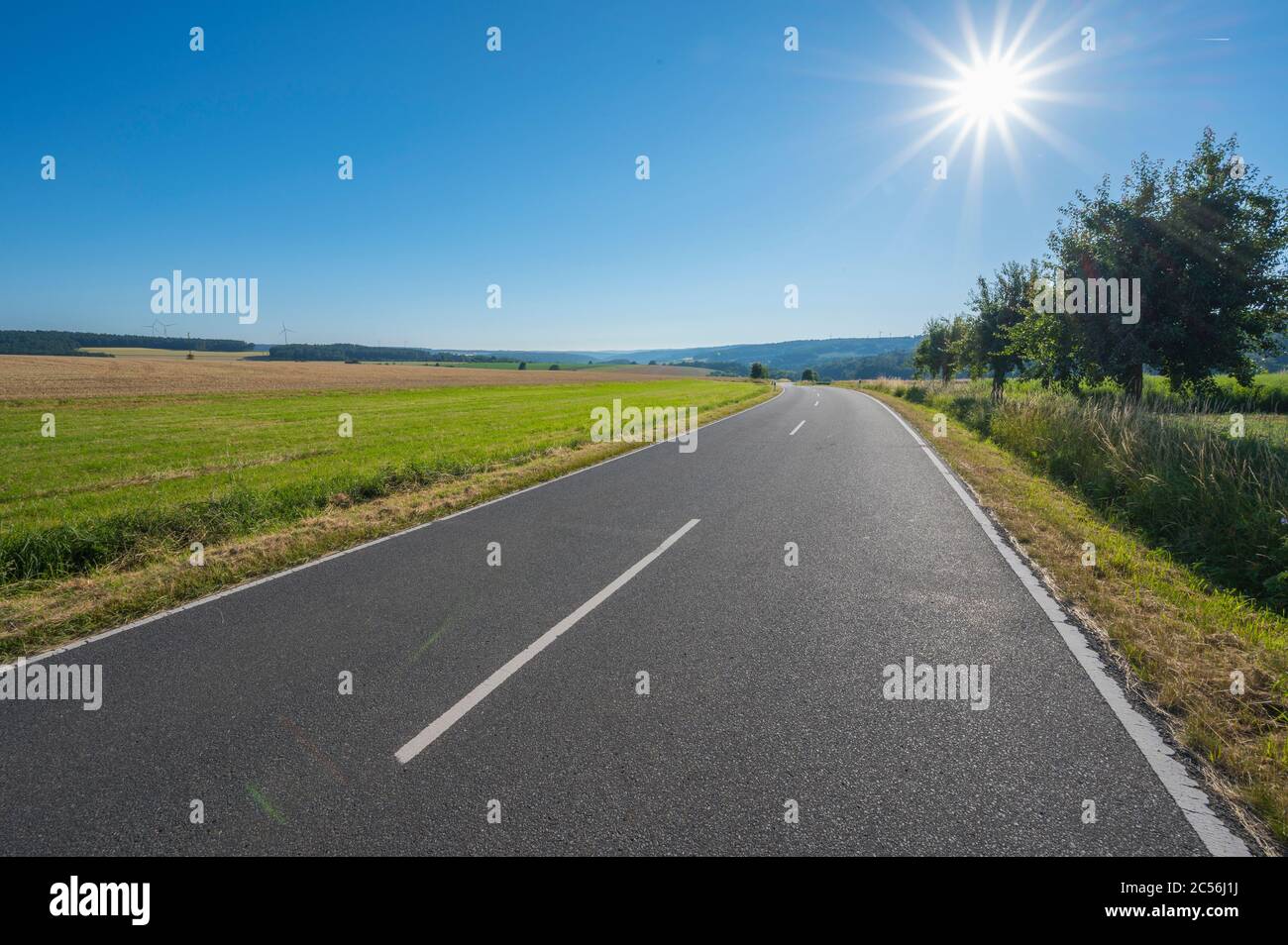Road with sun in summer Stock Photo - Alamy