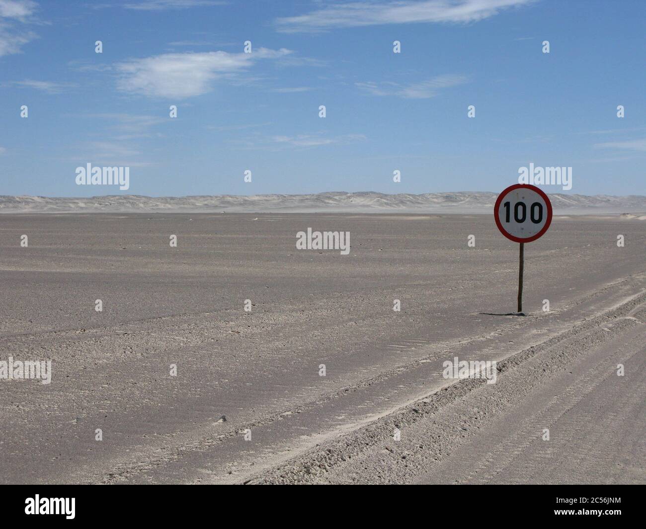 Sunny scenery of a desert road with a speed limit signpost in Skeleton ...