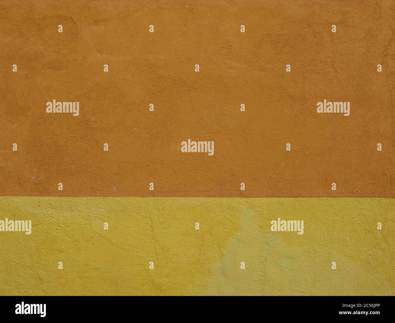 Sunny scenery of a yellow rough building facade Stock Photo - Alamy