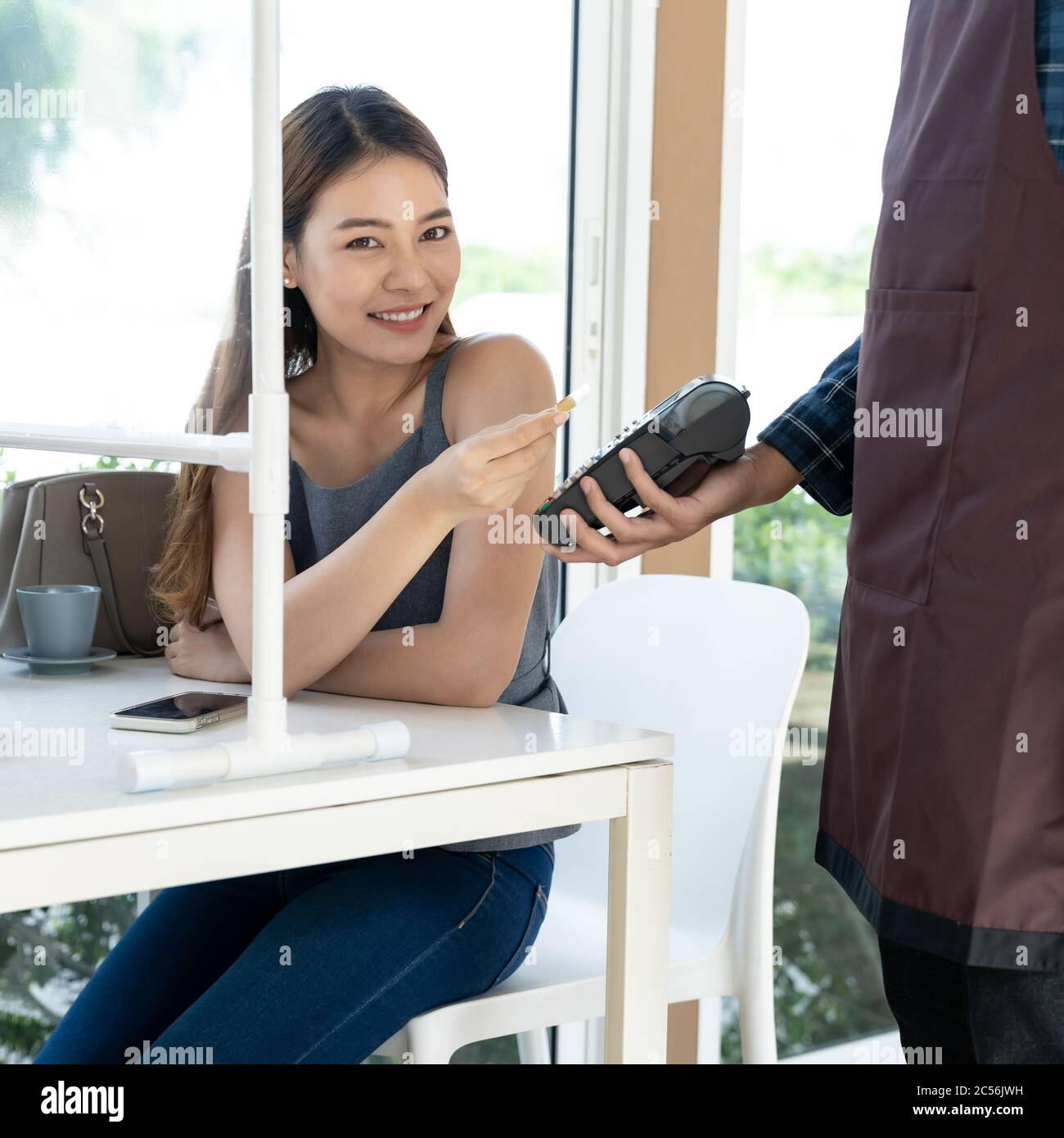Asian woman customer hold contactless credit card for making online ...