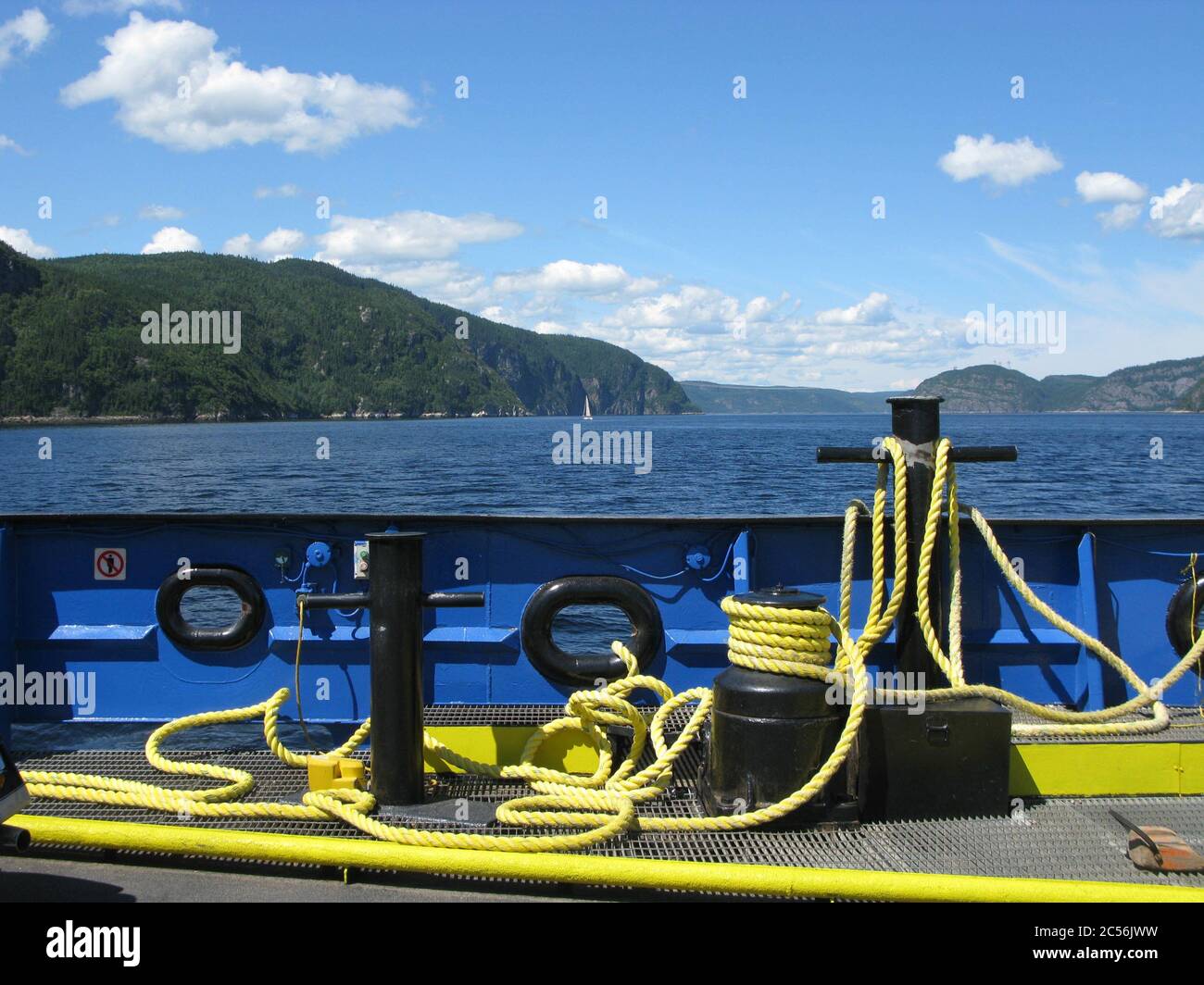 Beautiful shot of a new ship deck with yellow ropes sailing in a ...