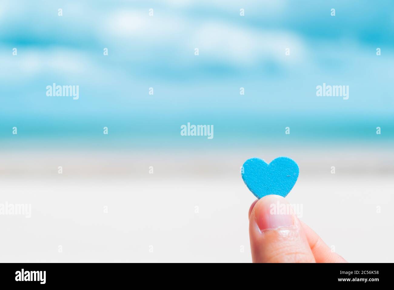 Hand hold little heart meaning feel love with summer beach with blue ...