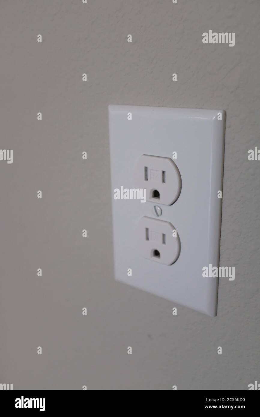 Vertical shot of an electric plug -- side view on the wall Stock Photo ...