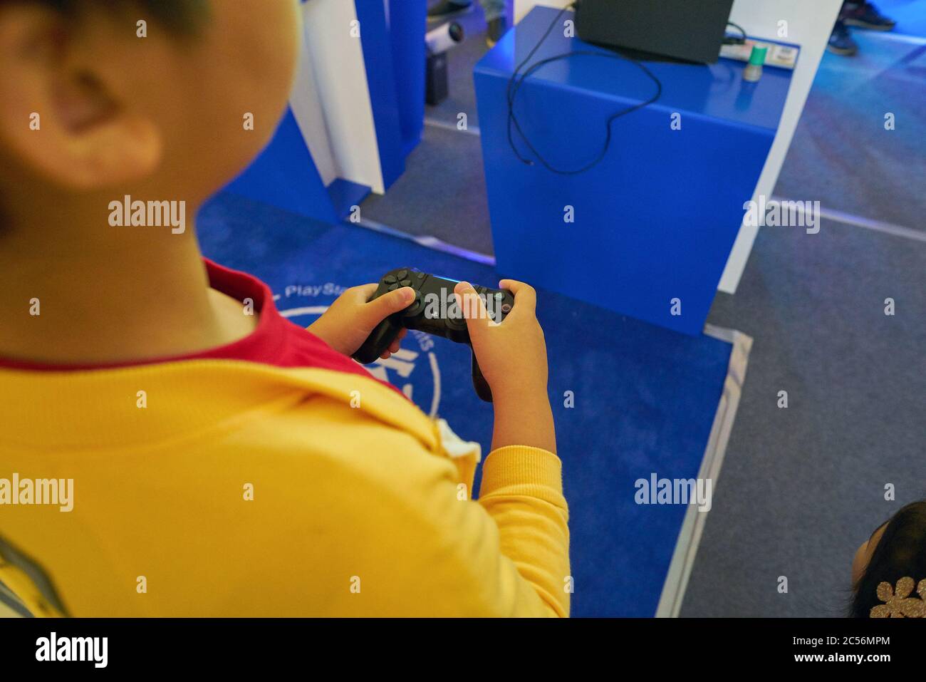 SHENZHEN, CHINA - CIRCA APRIL, 2019: boy hold PlayStation's controller ...