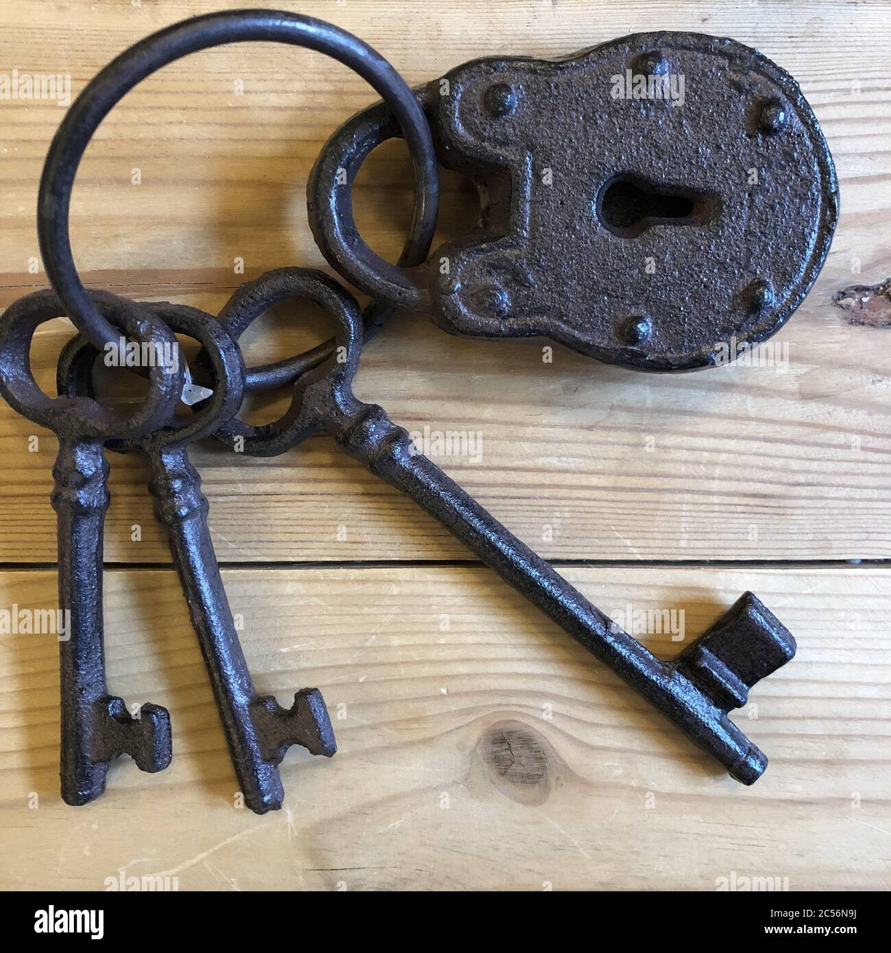 Closeup of an old lock with keys on the wooden table under the lights ...