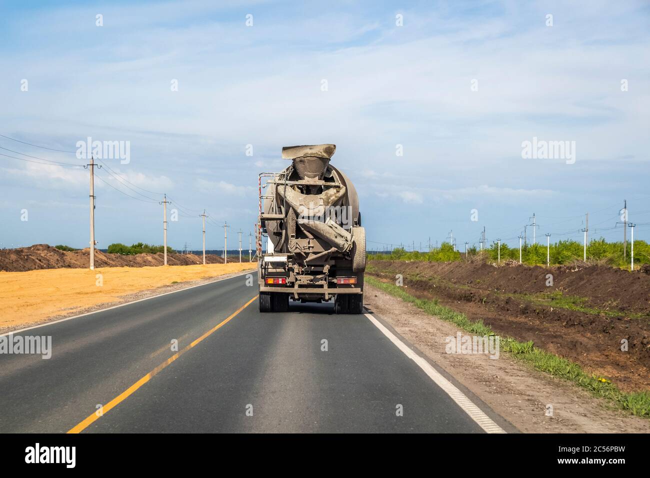 Concrete mixer rides on the road, carrying concrete to the construction ...
