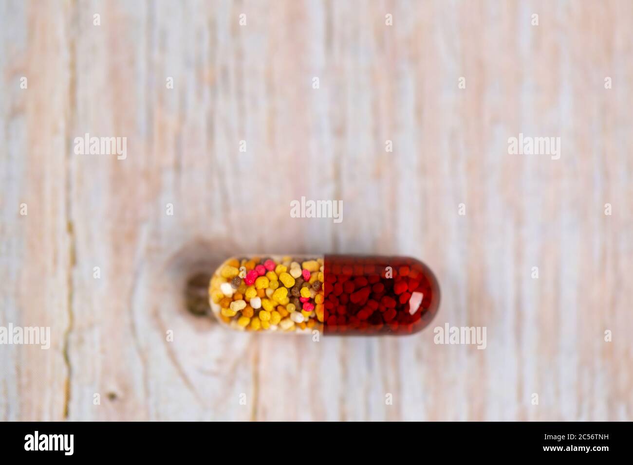 Home therapy. One red clear capsule of microgranules Stock Photo - Alamy