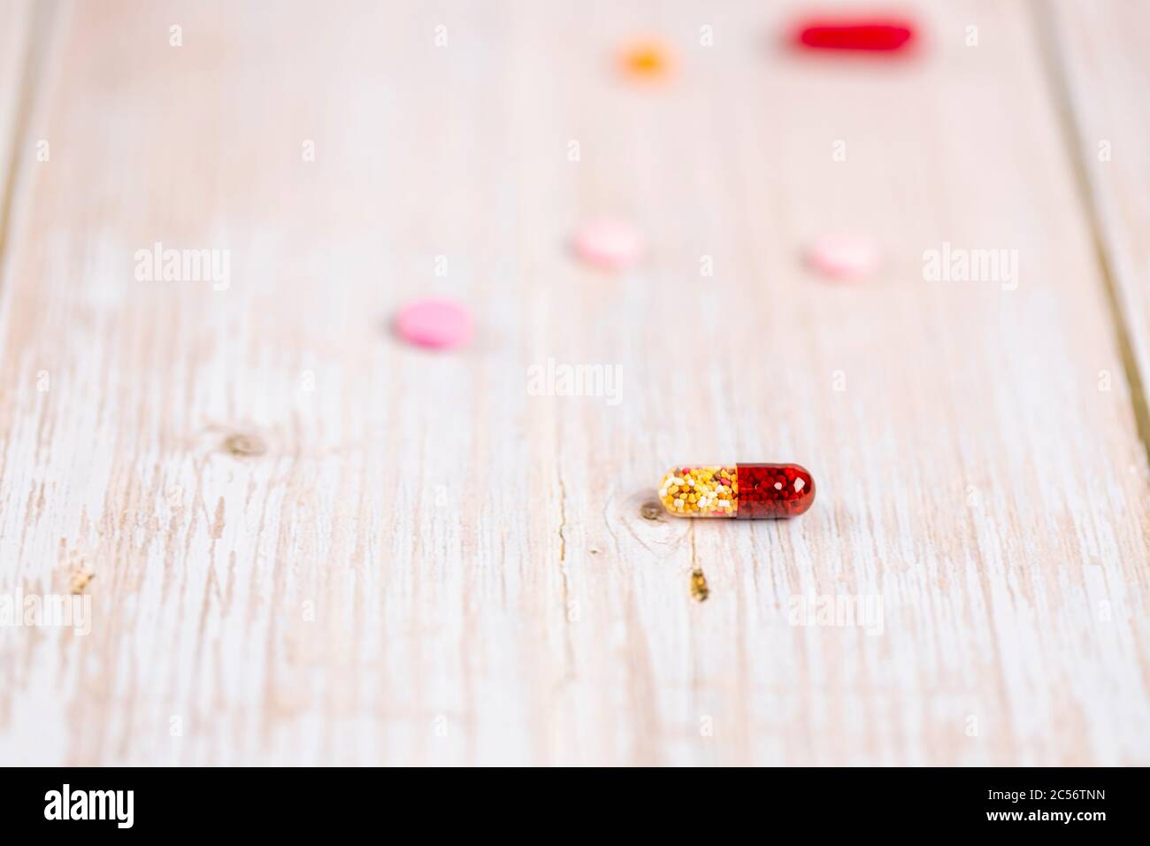 Home therapy. One red clear capsule of microgranules Stock Photo - Alamy