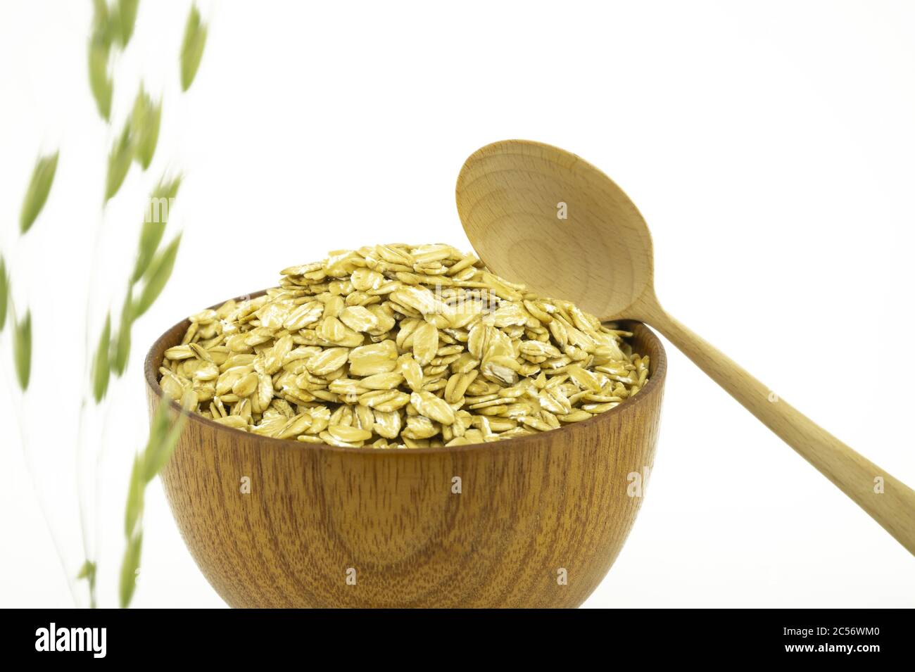 Green ear of oats with bowl of cereal in the background isolated on ...