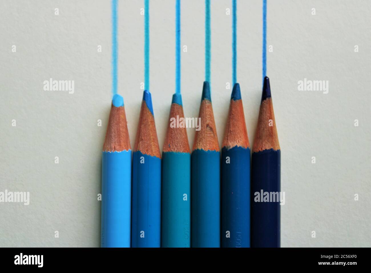 Blue colored pencils in different shades against corresponding drawn ...