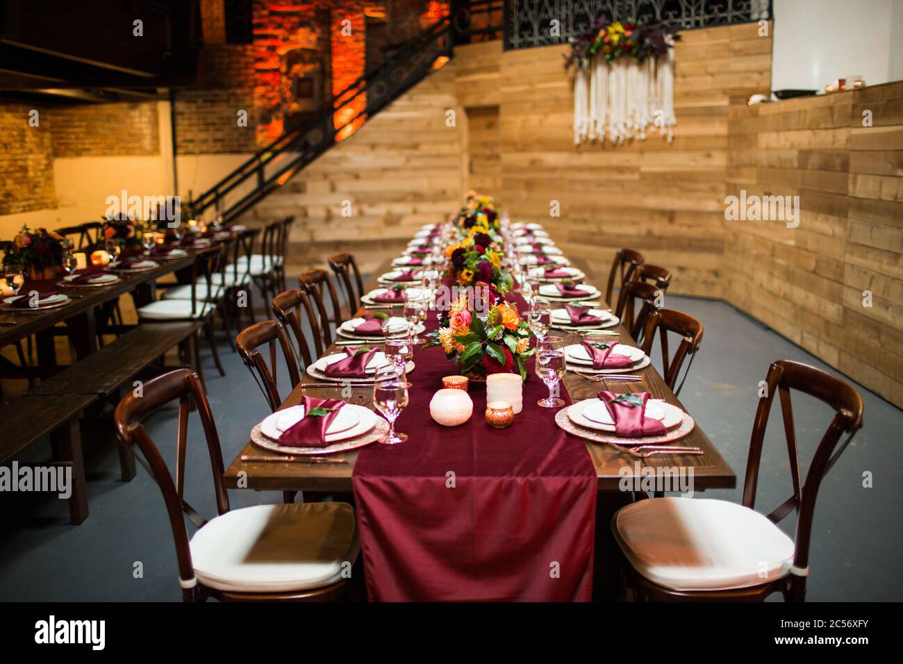 Long table covered with dark red texture and plates with splayds Stock ...