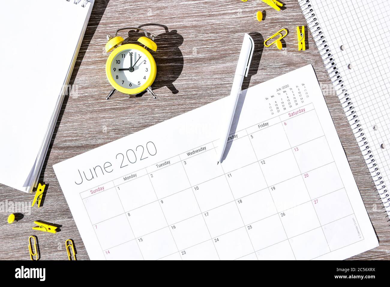 june 2020 calendar on wooden background with pencil, notebook, office ...