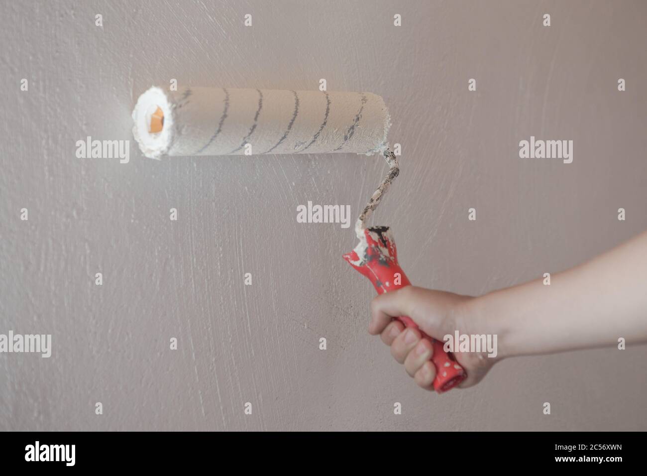 Hand painting using paint roller Stock Photo - Alamy