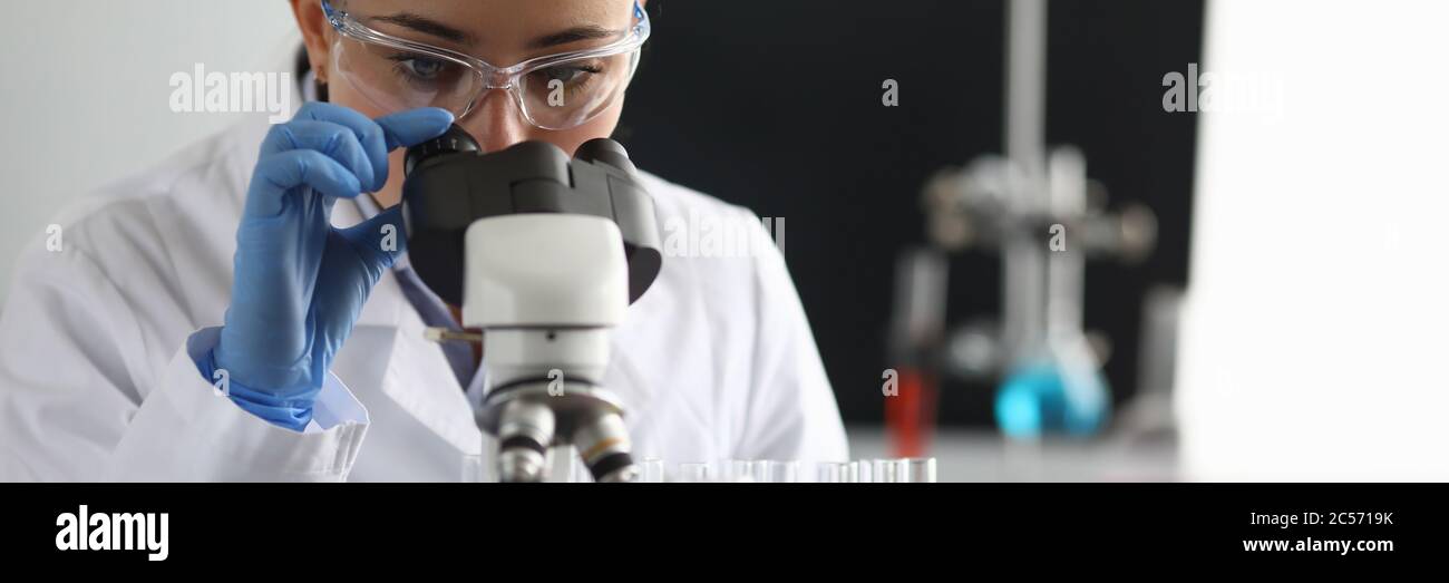 Laboratory assistant using microscope hi-res stock photography and ...