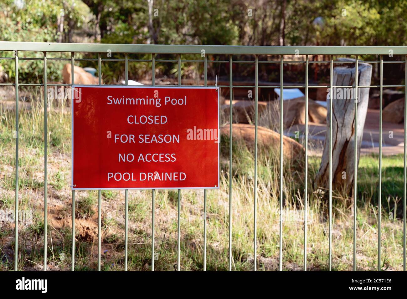 Swimming pool closure sign on caravan park fence notifying closed for ...