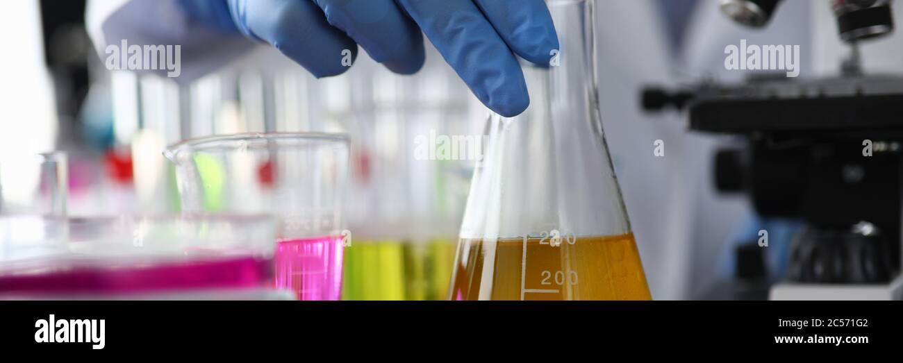 Scientist mixing chemical fluid Stock Photo - Alamy