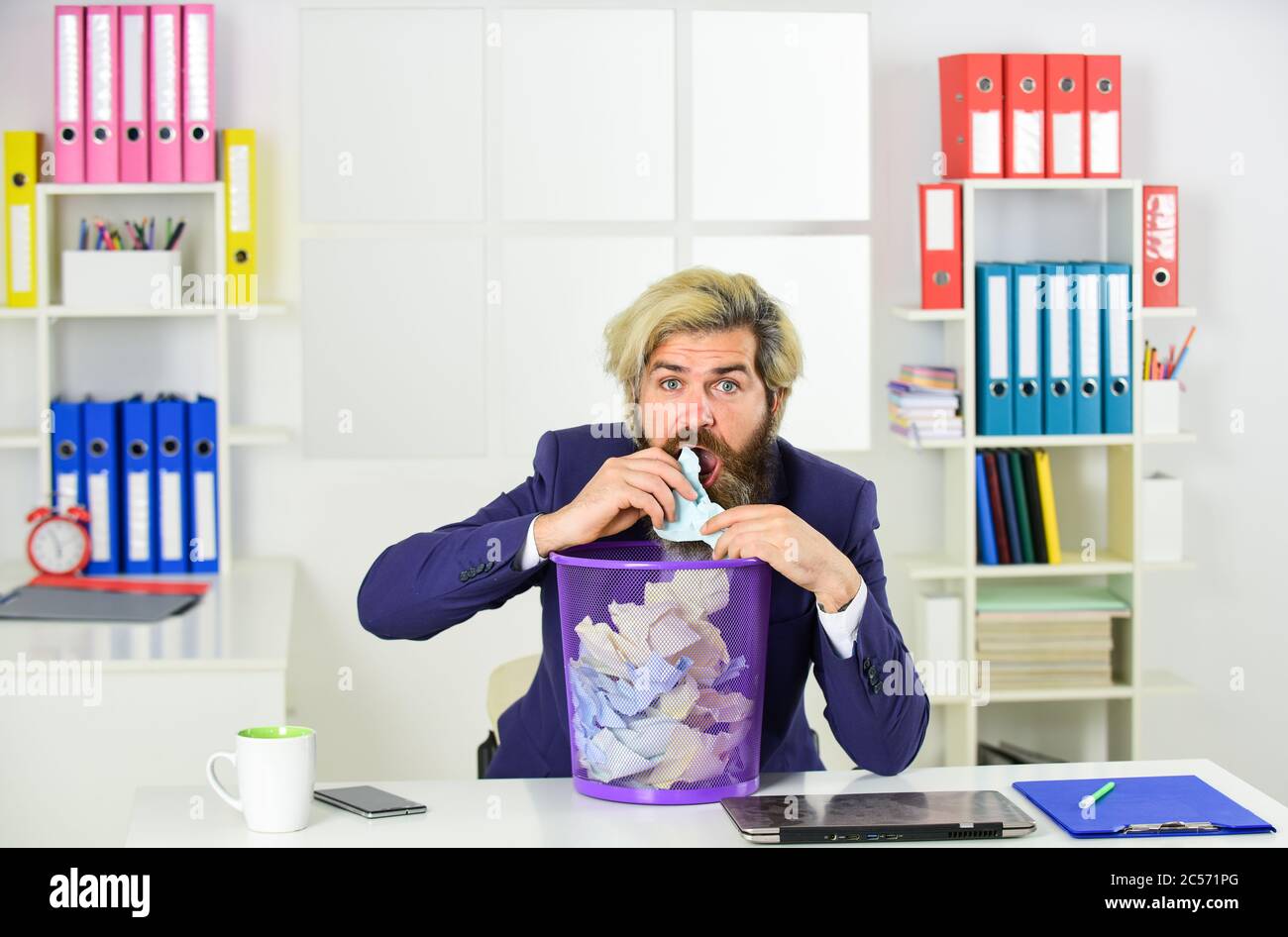 Rummaging through the papers. Businessman hold trash can. Man look for ...