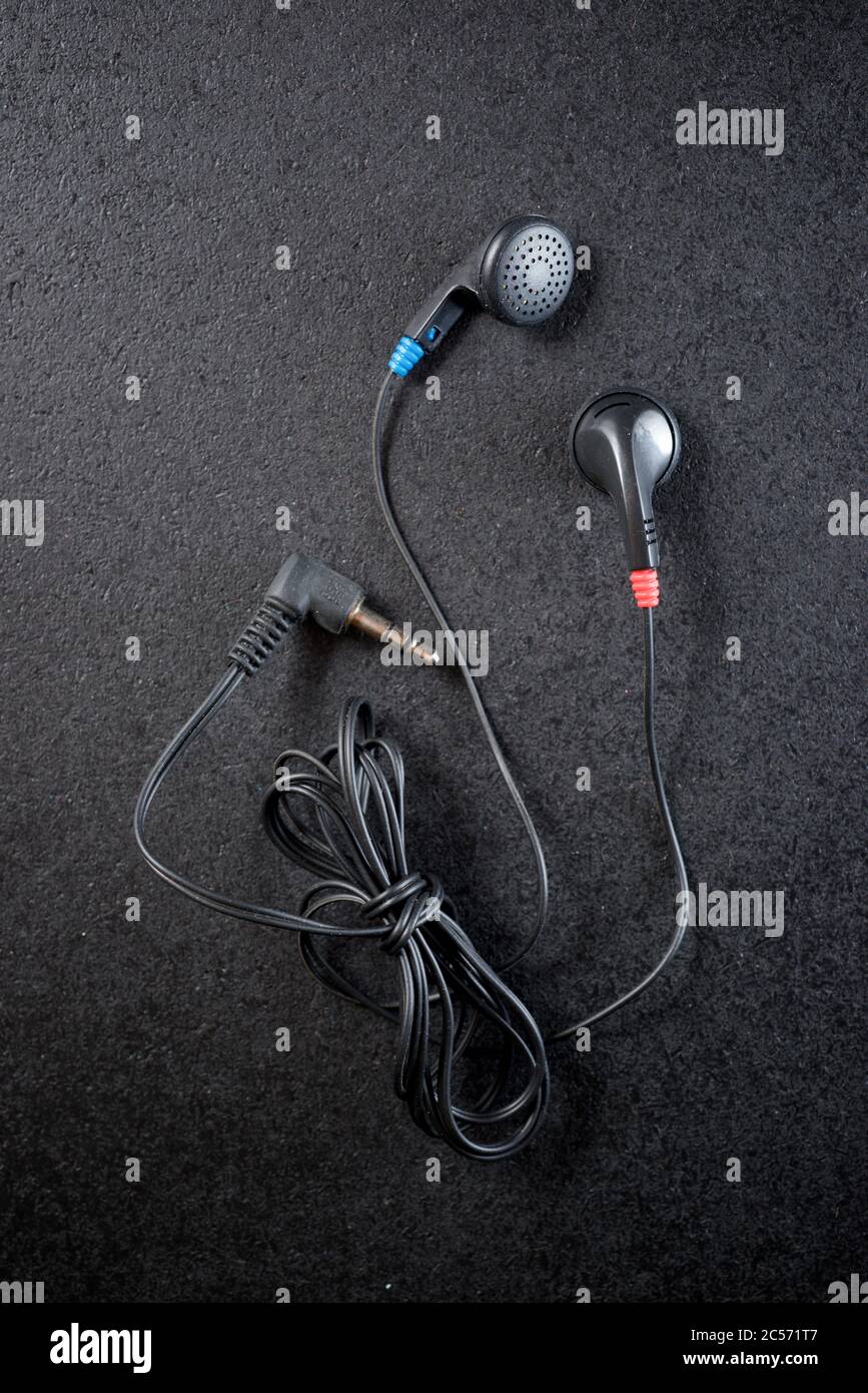 Small headphones on a black table Stock Photo - Alamy