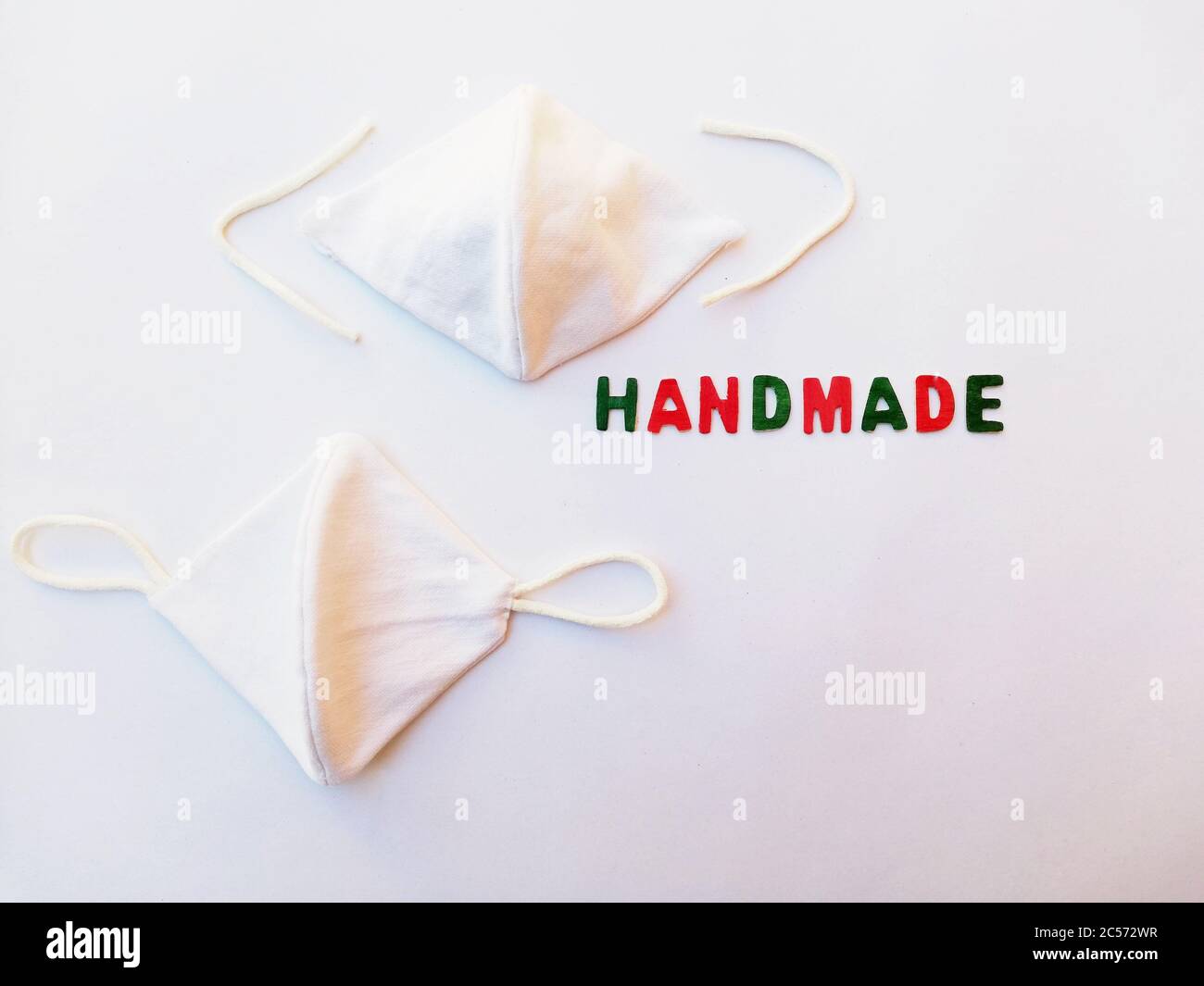 Overhead top view of handmade cotton masks against coronavirus on a ...