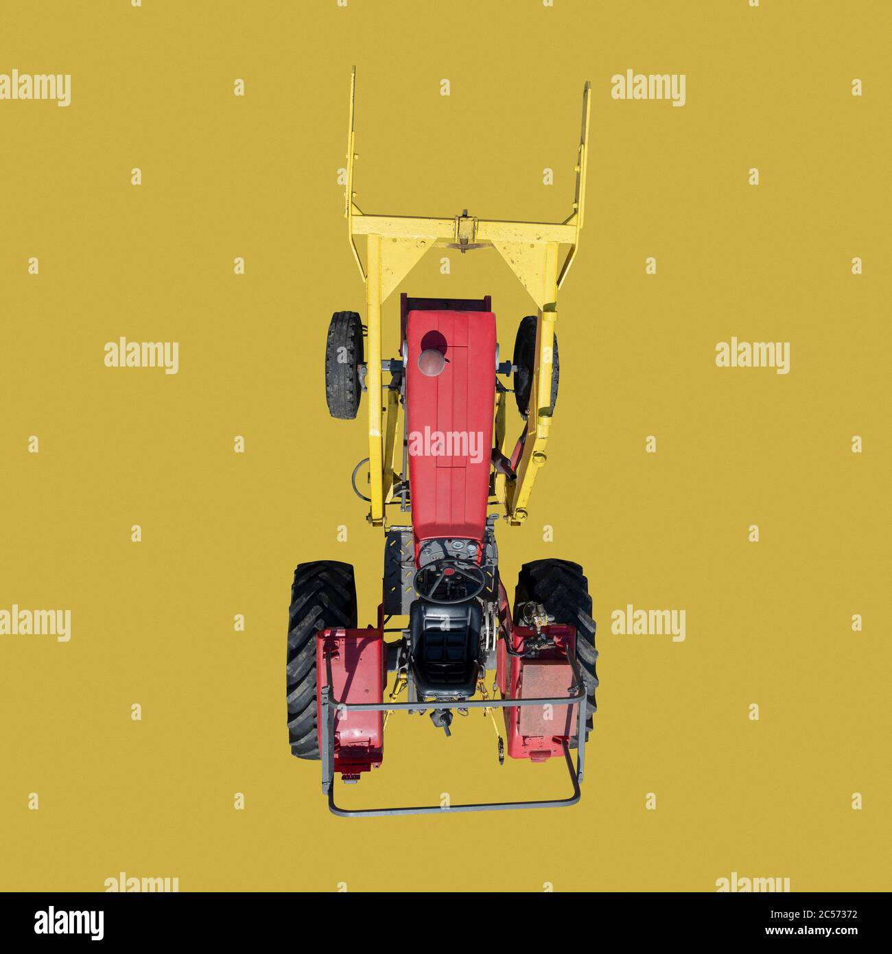 View from above red tractor on yellow background Stock Photo - Alamy