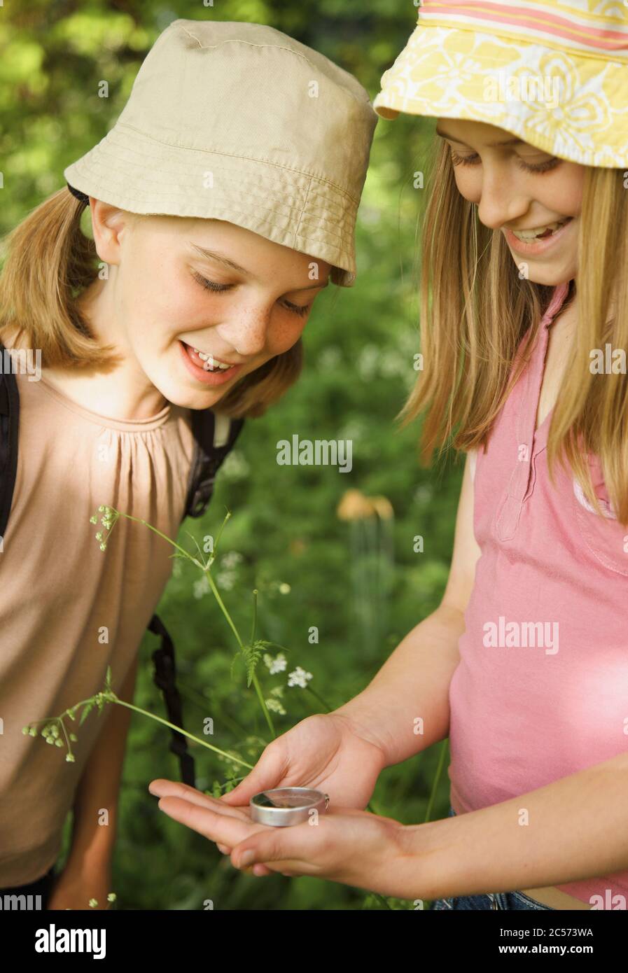 Girls with compass exploring Stock Photo - Alamy