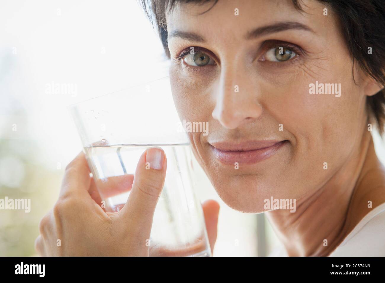Close up portrait woman drinking water Stock Photo - Alamy