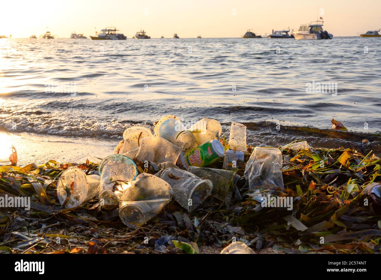 Washed-up plastic and plastic residues on the beach at sunrise, Pantai ...