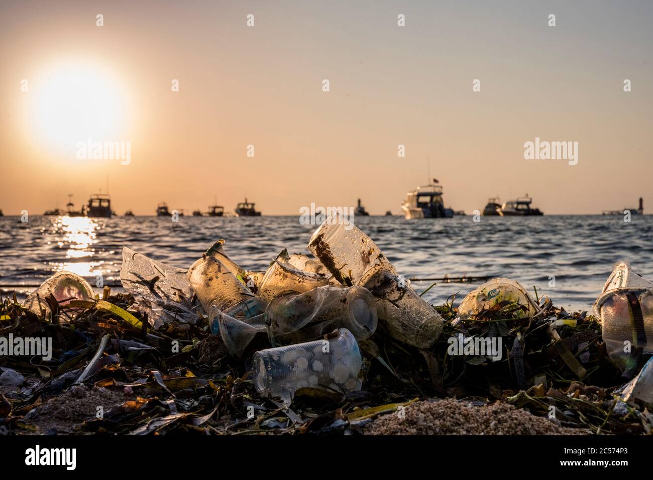 Washed-up plastic and plastic residues on the beach at sunrise, Pantai ...