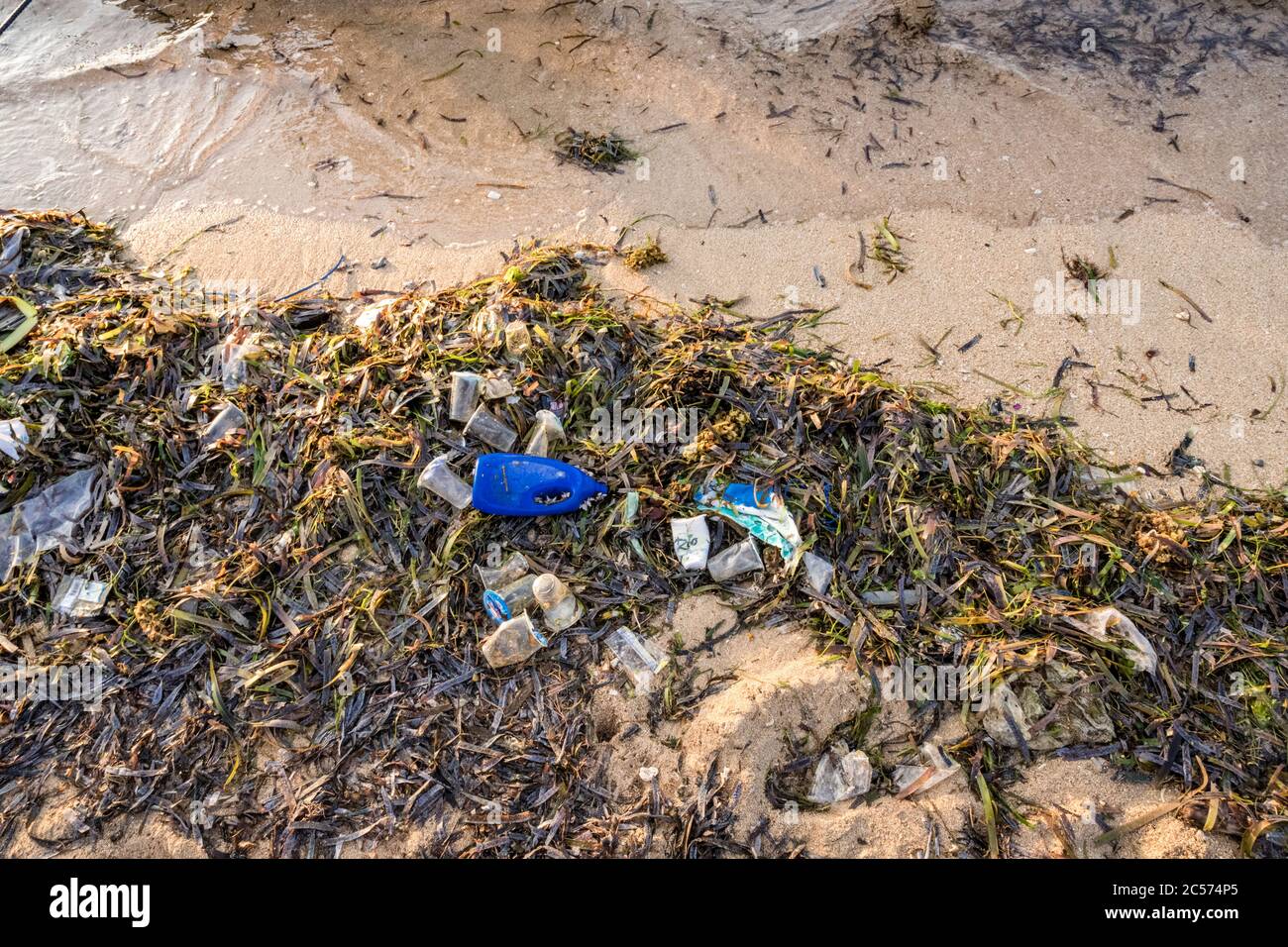 Washed-up plastic and plastic residues on the beach at sunrise, Pantai ...