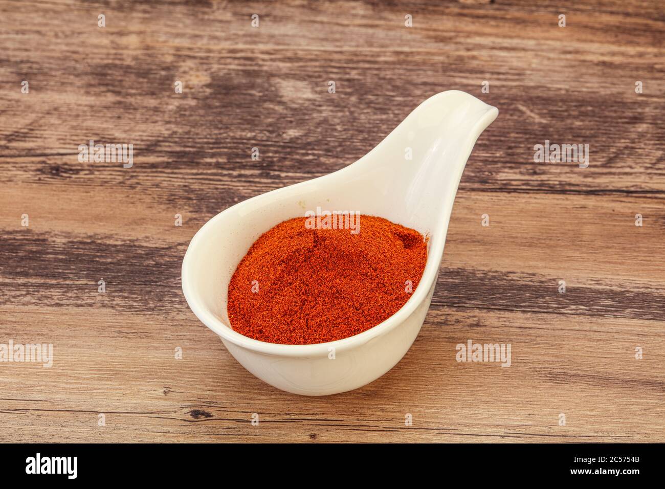 Dry paprika powder in the bowl for cooking Stock Photo - Alamy