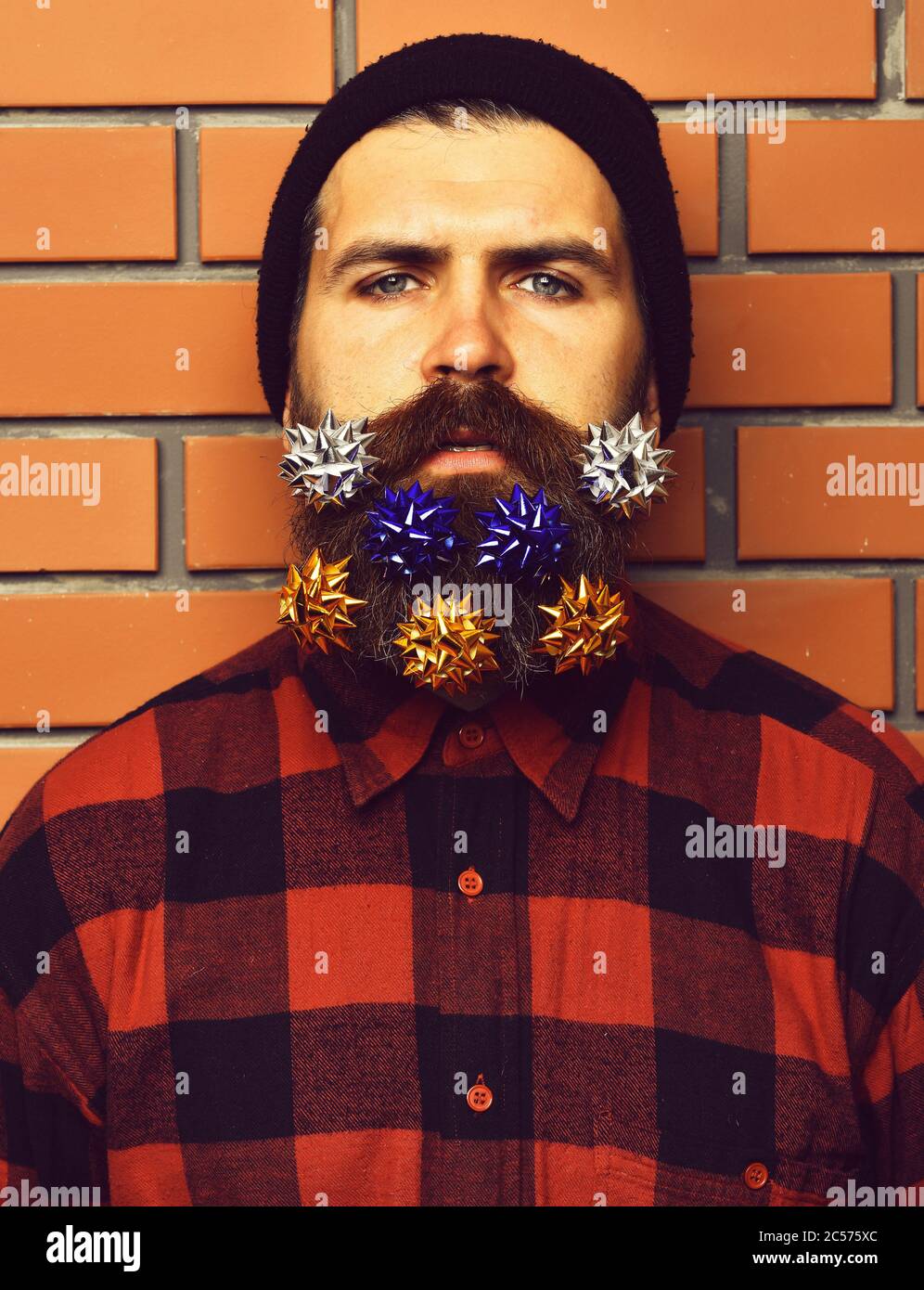 Bearded man with flowers or bows in long beard. Brutal caucasian ...