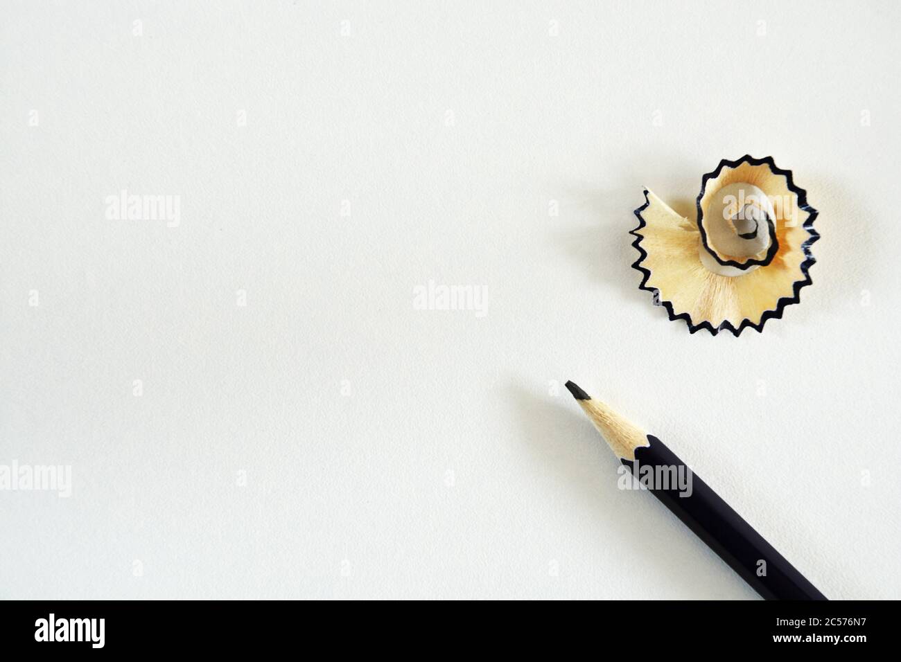 Closeup shot of a pencil with a pencil shavings isolated on white ...