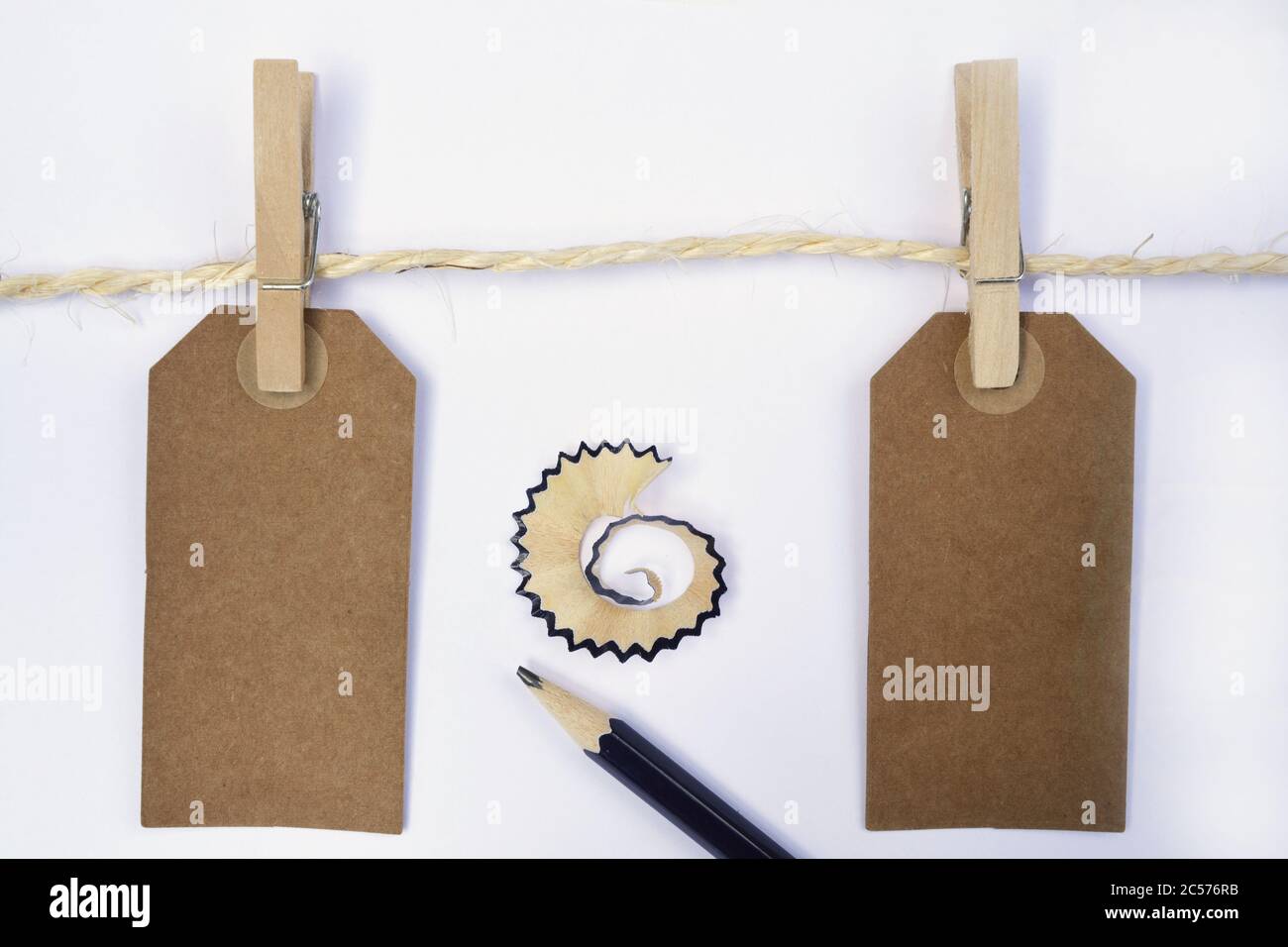Empty copy space tags on the rope with a pencil and pencil shavings ...