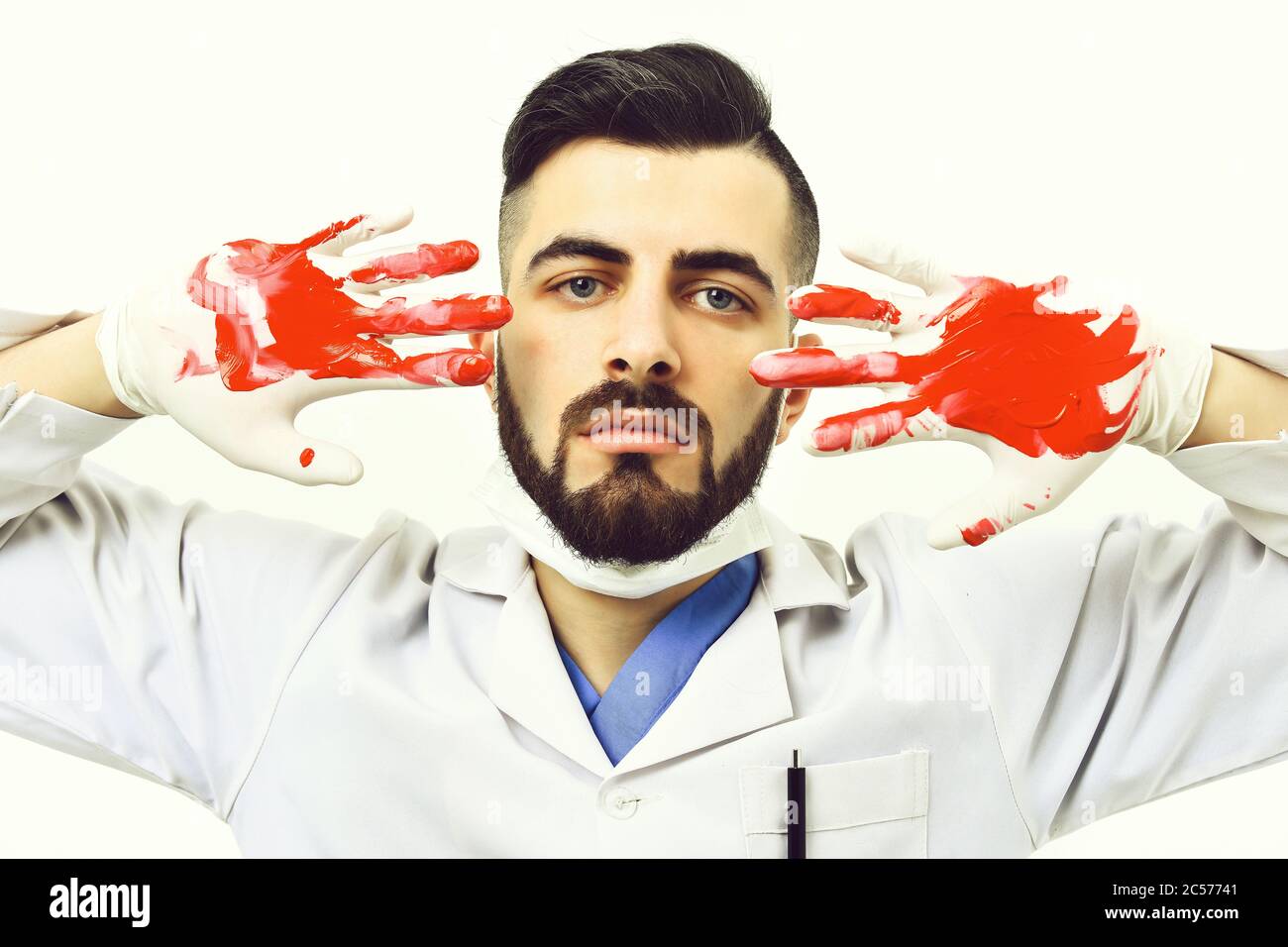 Surgeon with dark beard and serious face expression showing his hands ...