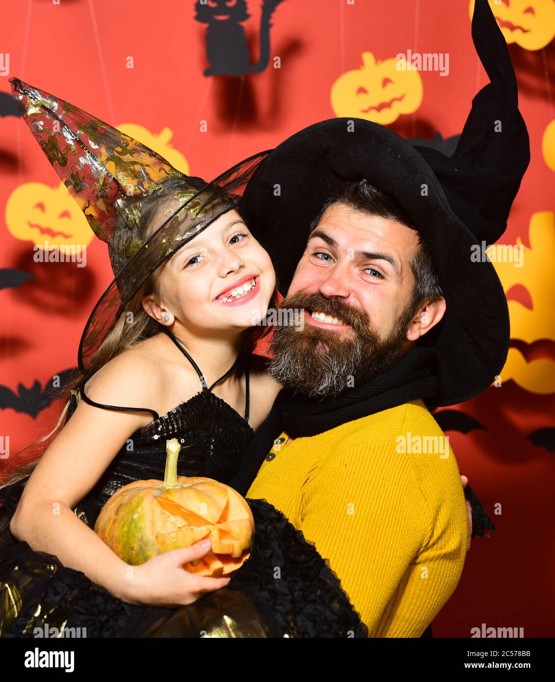 Halloween party and celebration concept. Girl and bearded man with ...