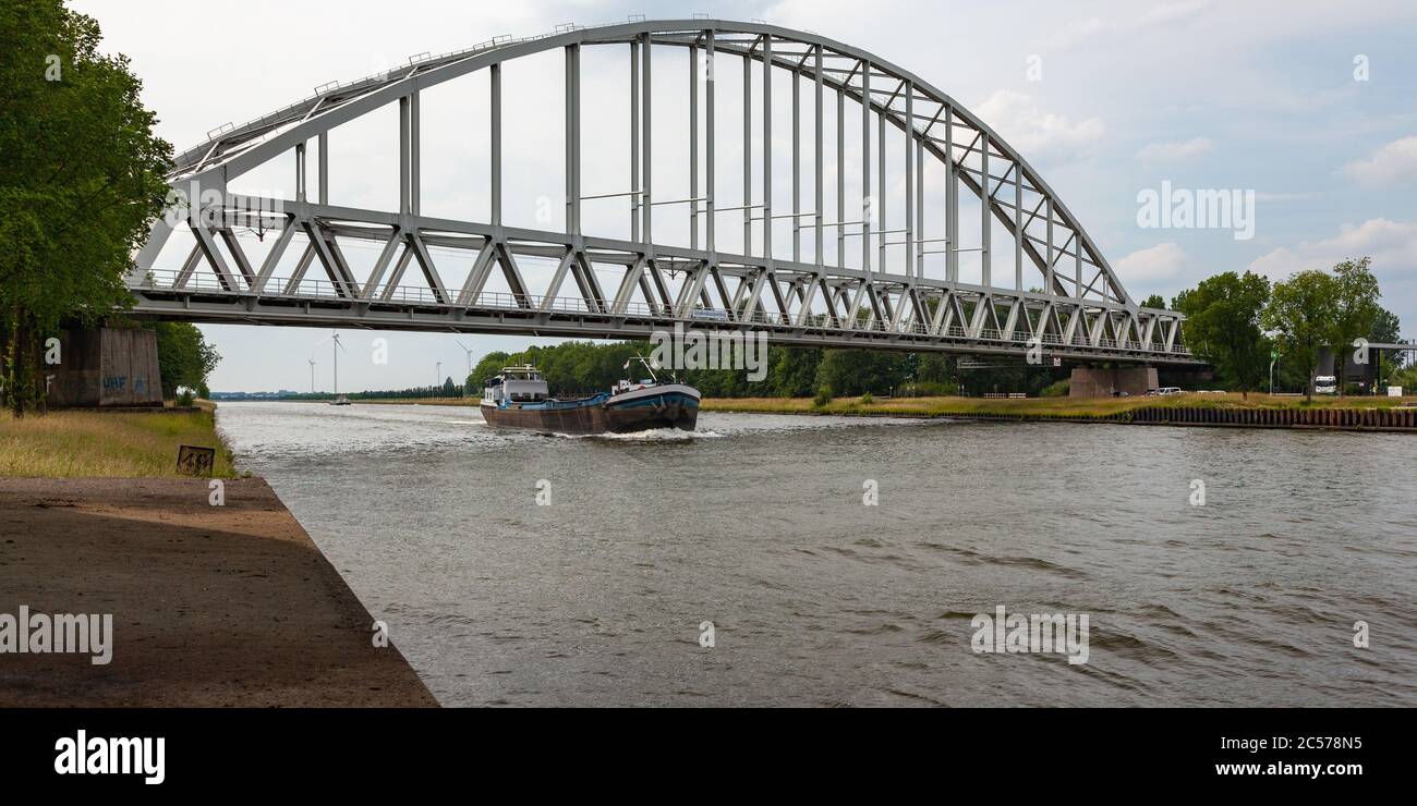 Inland transport vessel under a railroad bridge in the Netherlands ...