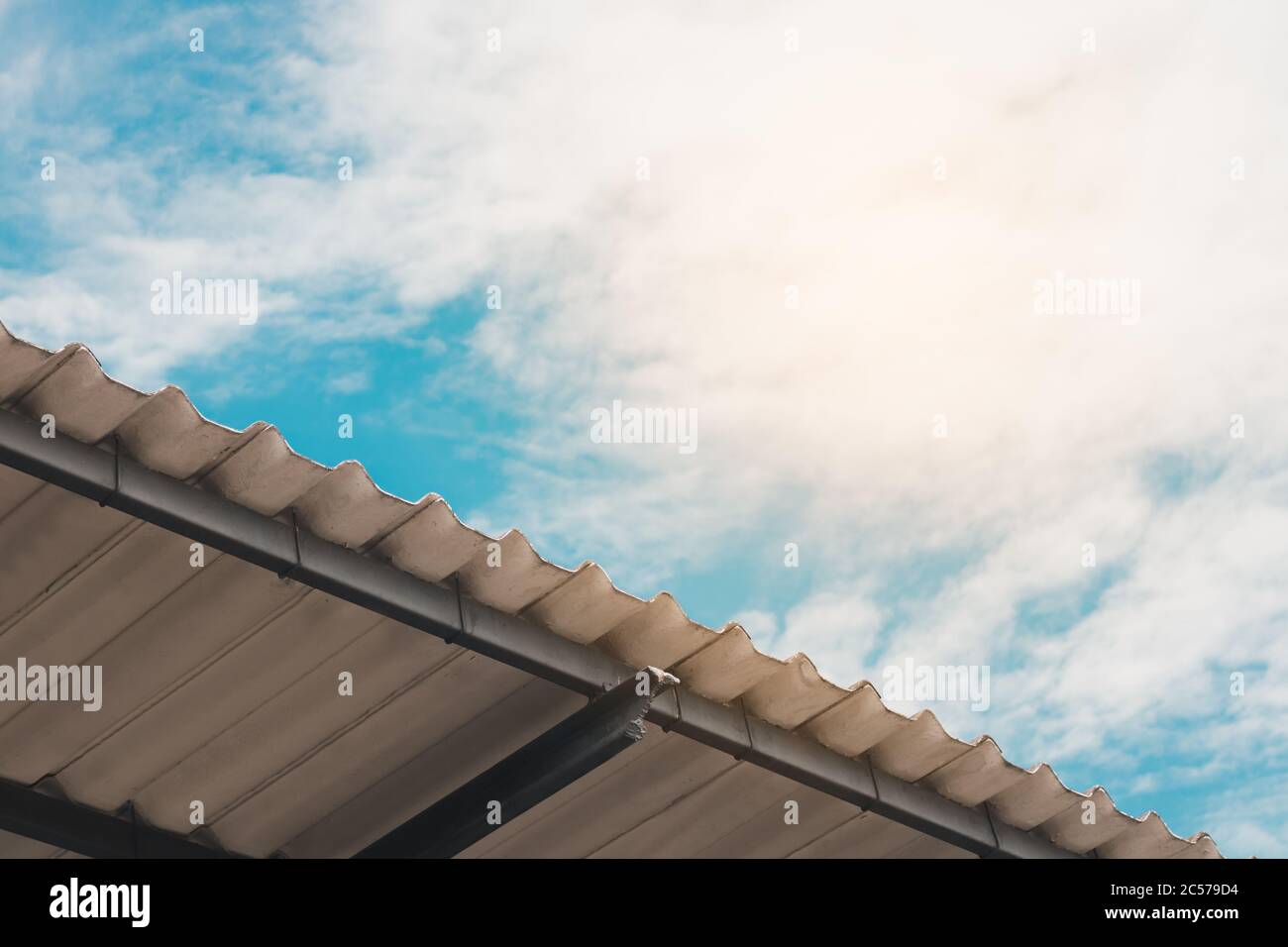 Roof tiles and blue sky with clouds Stock Photo - Alamy