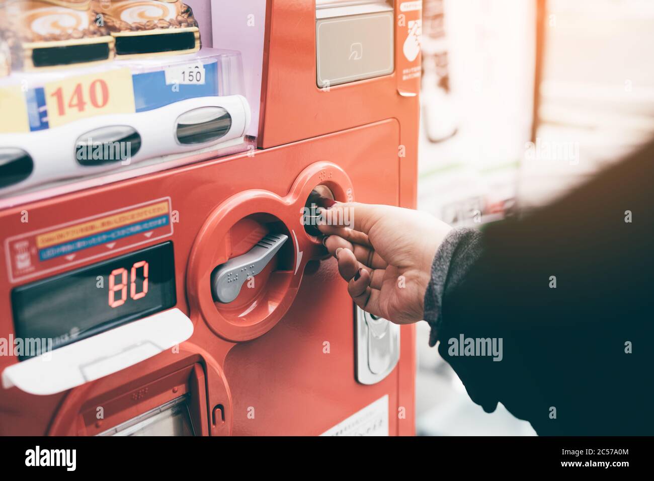 Woman hand inserting coin in vending machine at street public Stock ...