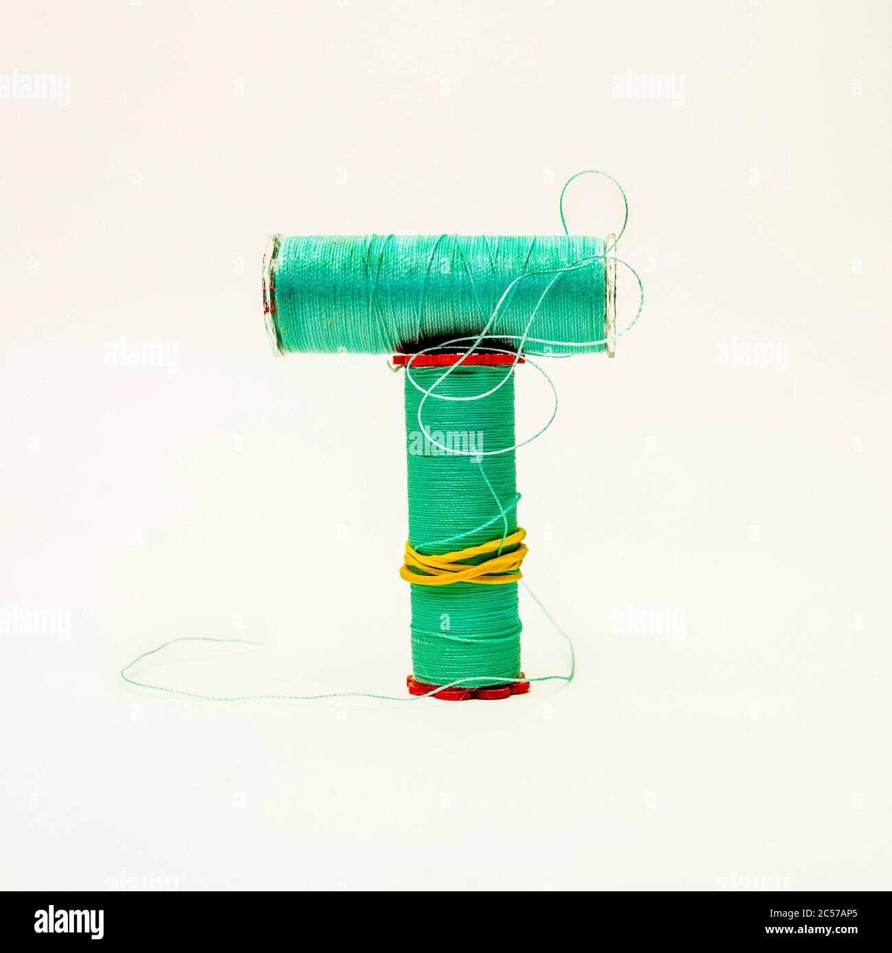 Bobbin of thread on a white background Stock Photo - Alamy