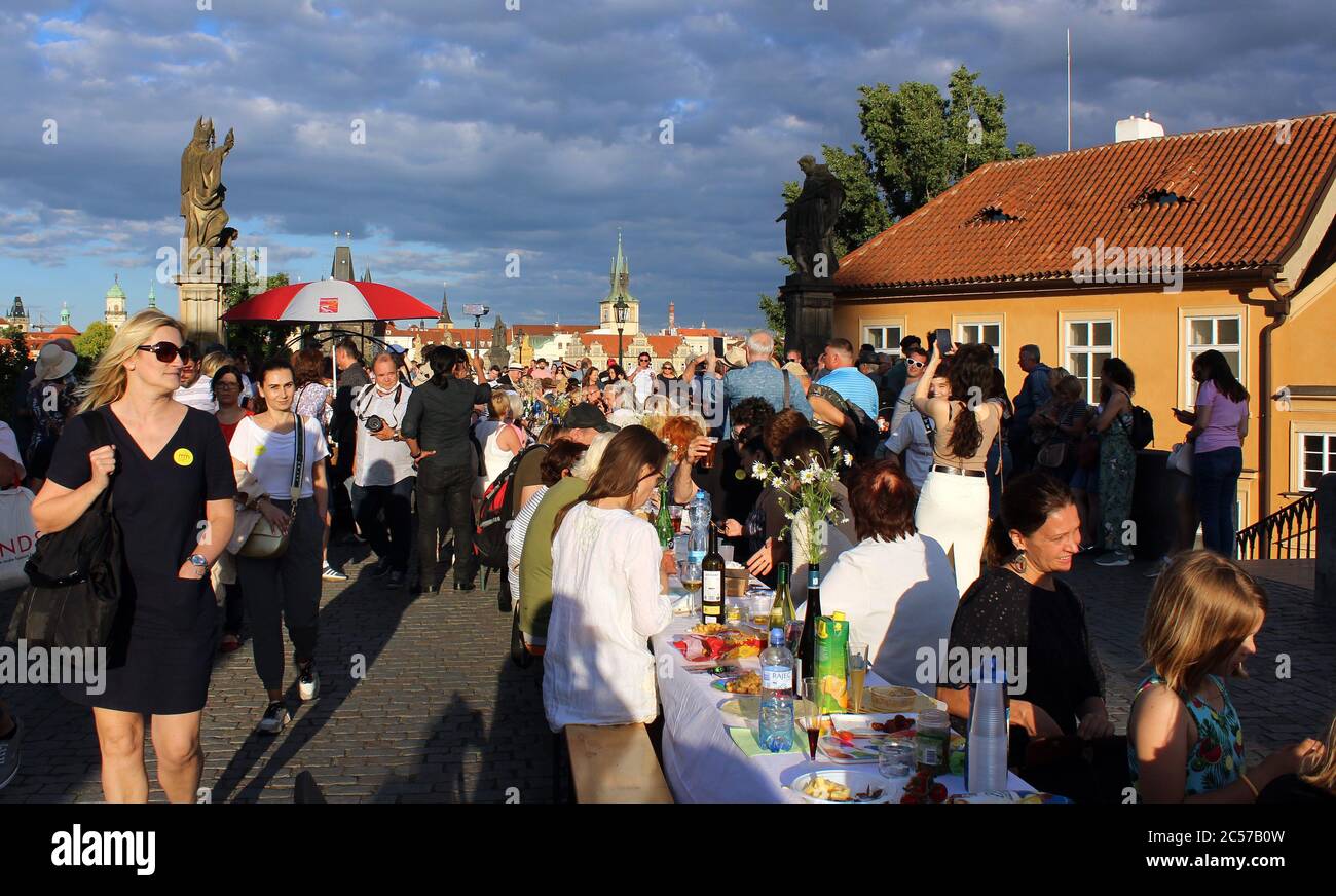 Prague citizens see coronavirus out with dinner at 500 metre long table ...
