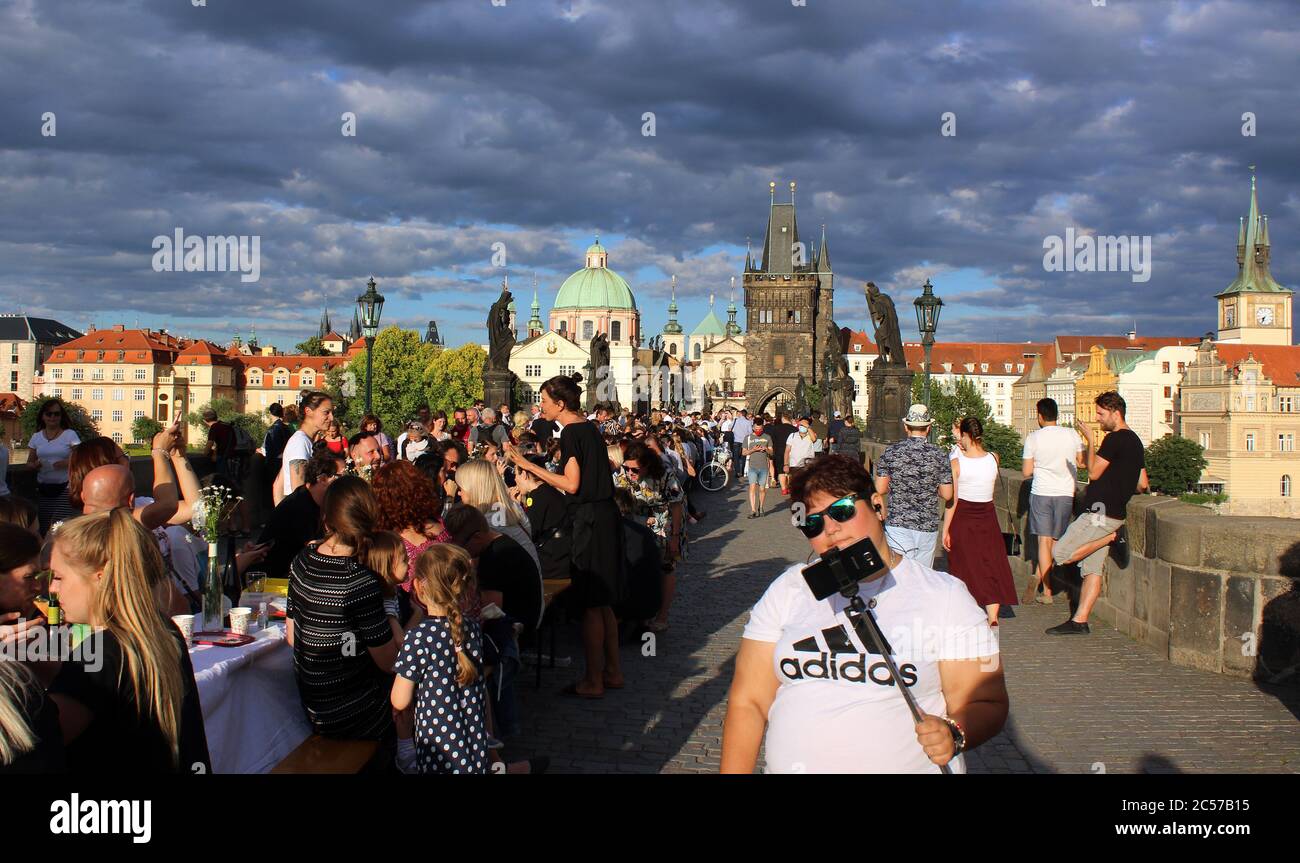 Prague citizens see coronavirus out with dinner at 500 metre long table ...