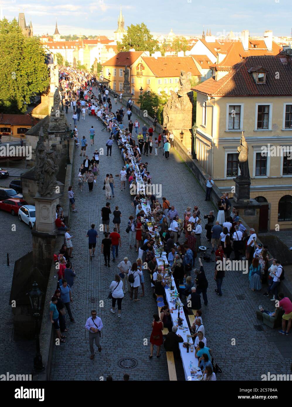 Prague citizens see coronavirus out with dinner at 500 metre long table ...