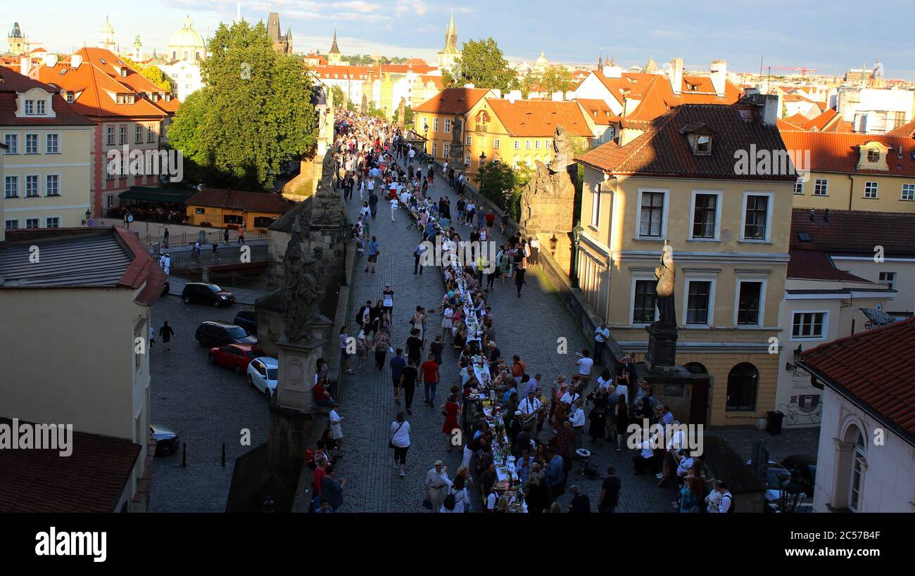 Prague citizens see coronavirus out with dinner at 500 metre long table ...